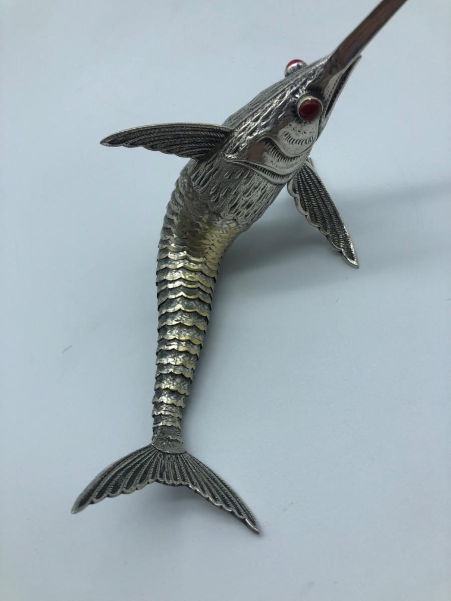 A Spanish 800 silver and partially gilded swordfish resting on two ...